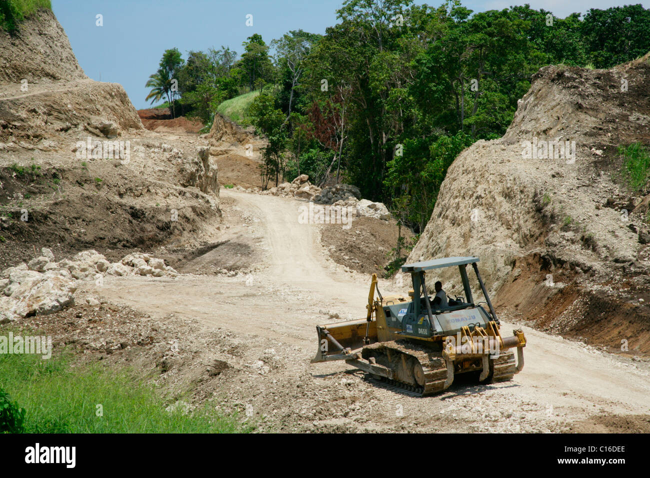 Earth mover building a road for the refinery and harbour area of the ...