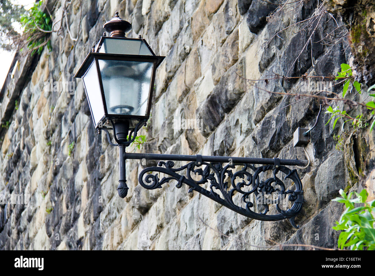 Antique lamp attached to ancient stone wall in Florence Stock Photo - Alamy