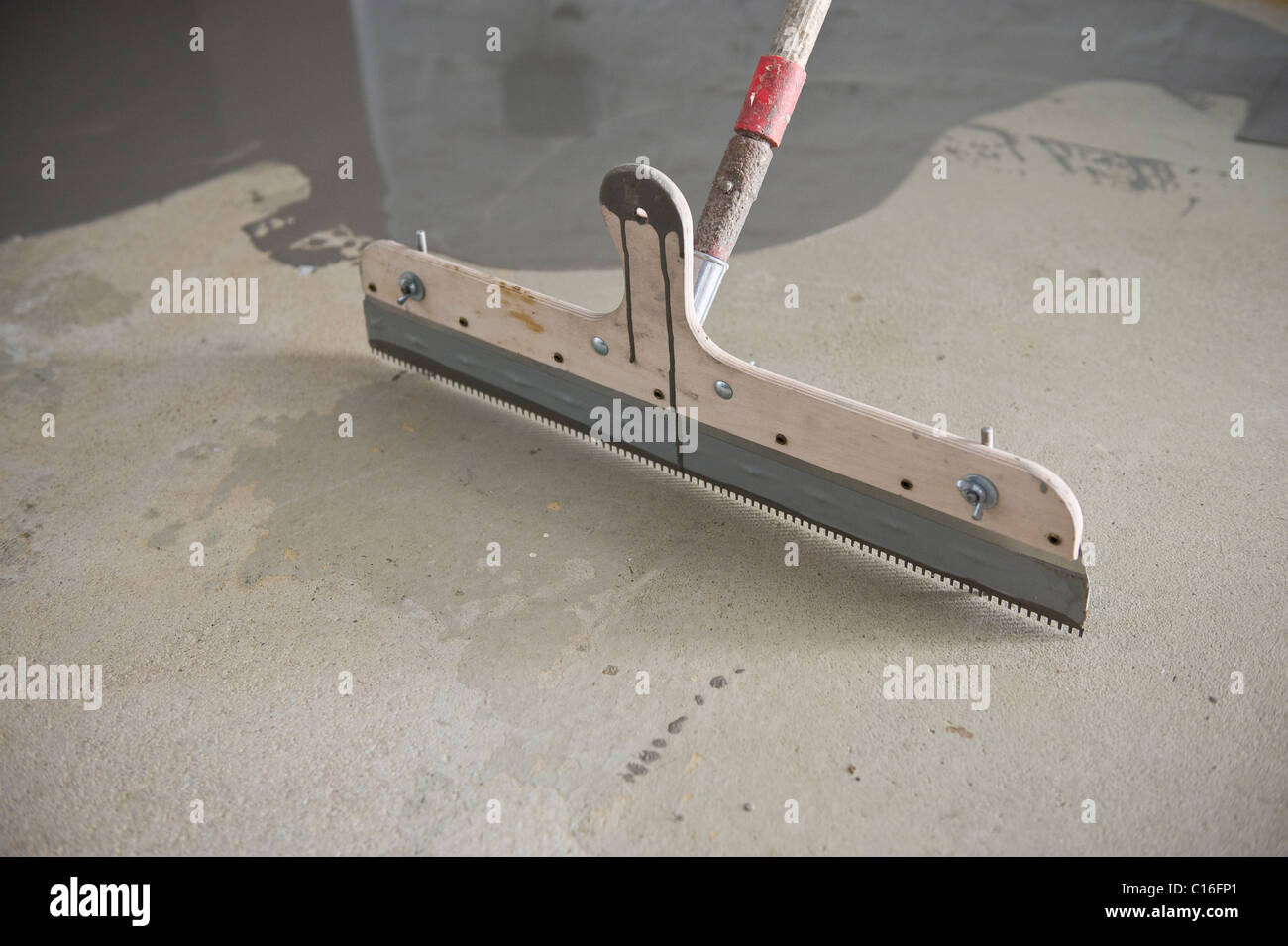 Concrete filler surface and rake Stock Photo - Alamy