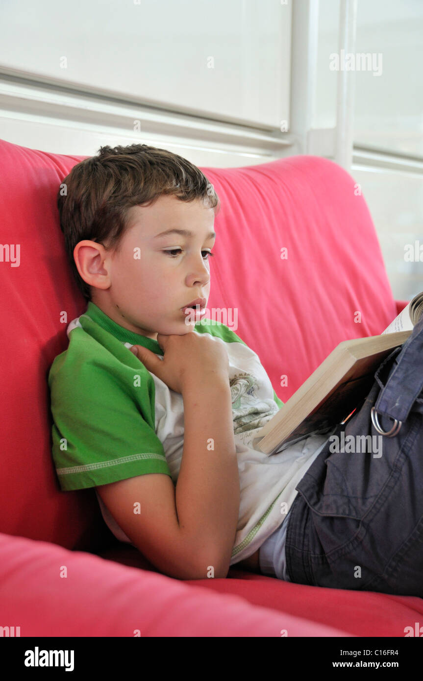 Boy reading a book Stock Photo - Alamy