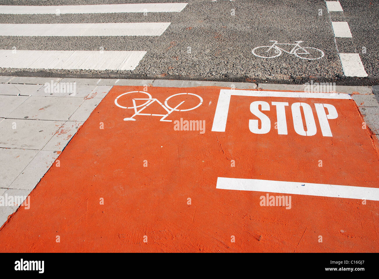 Orange bicycle lane with a STOP sign Stock Photo - Alamy
