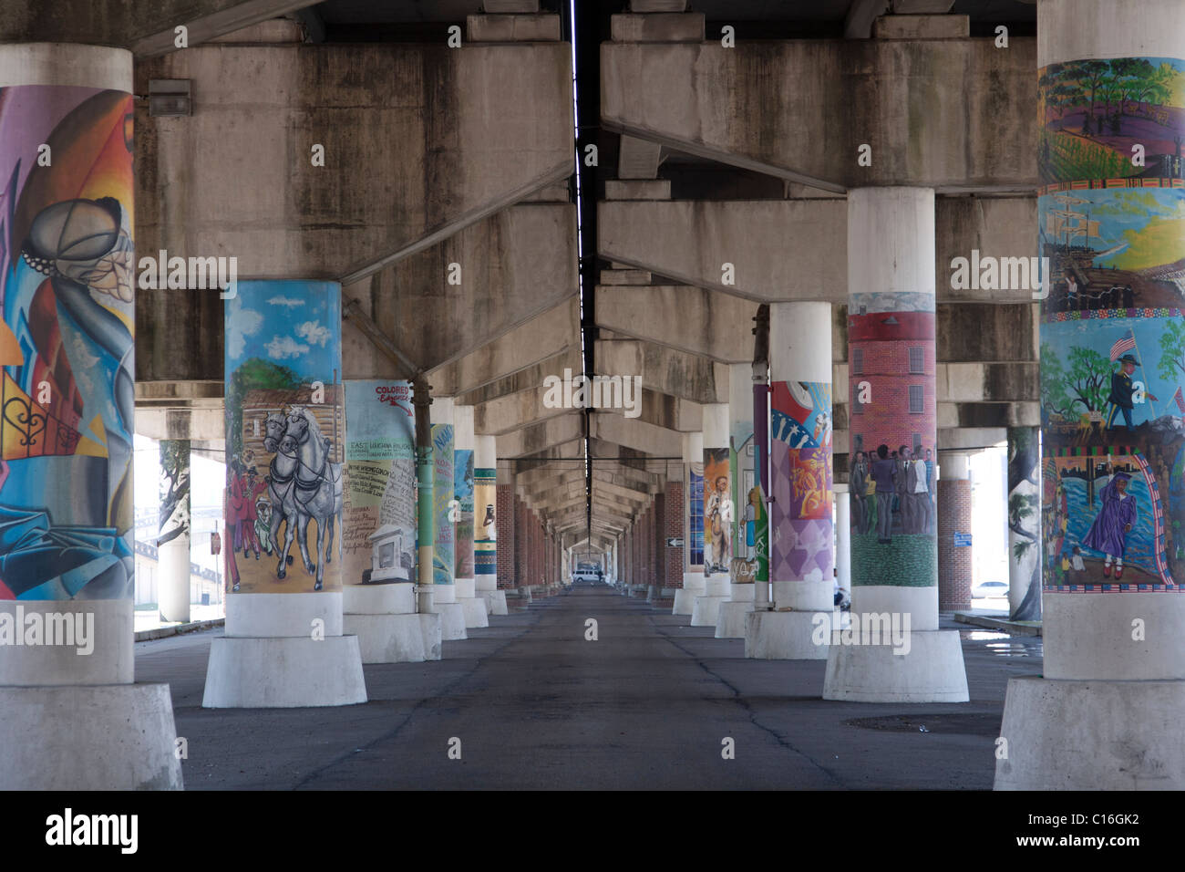 Underneath a highway overpass with artistically decorated pillars in ...