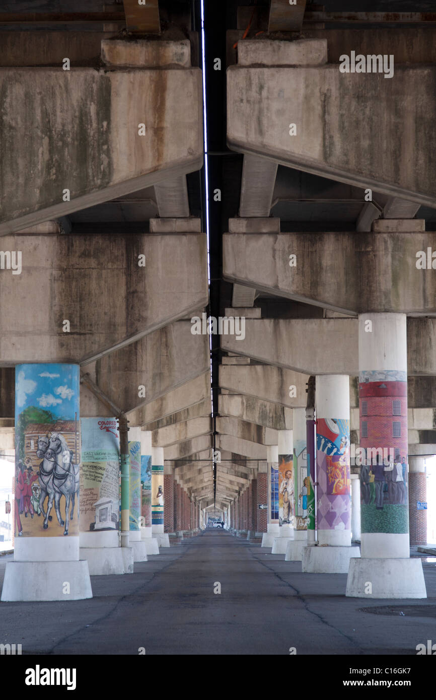 Underneath a highway overpass with artistically decorated pillars in ...