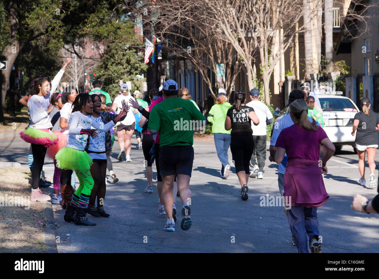 Girls giving high fives and cheering on runners in the New Orleans rock ...