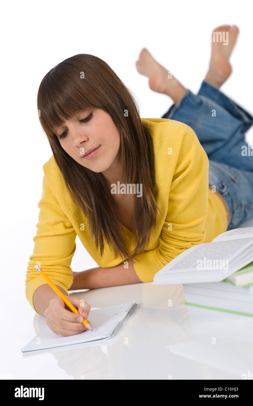 Student - female teenager write homework with book on white background ...