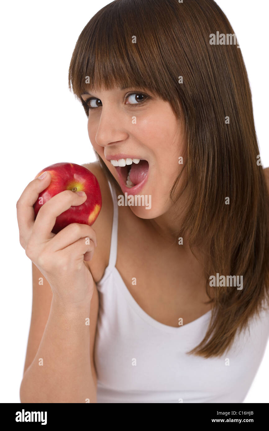Female teenager eat apple for breakfast on white background Stock Photo ...