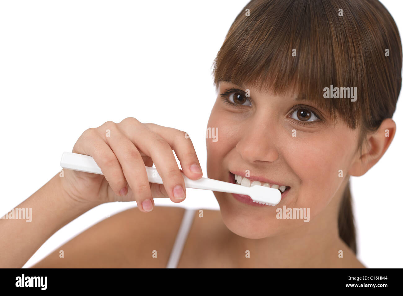 Body care - Female teenager brushing teeth with white toothbrush Stock ...