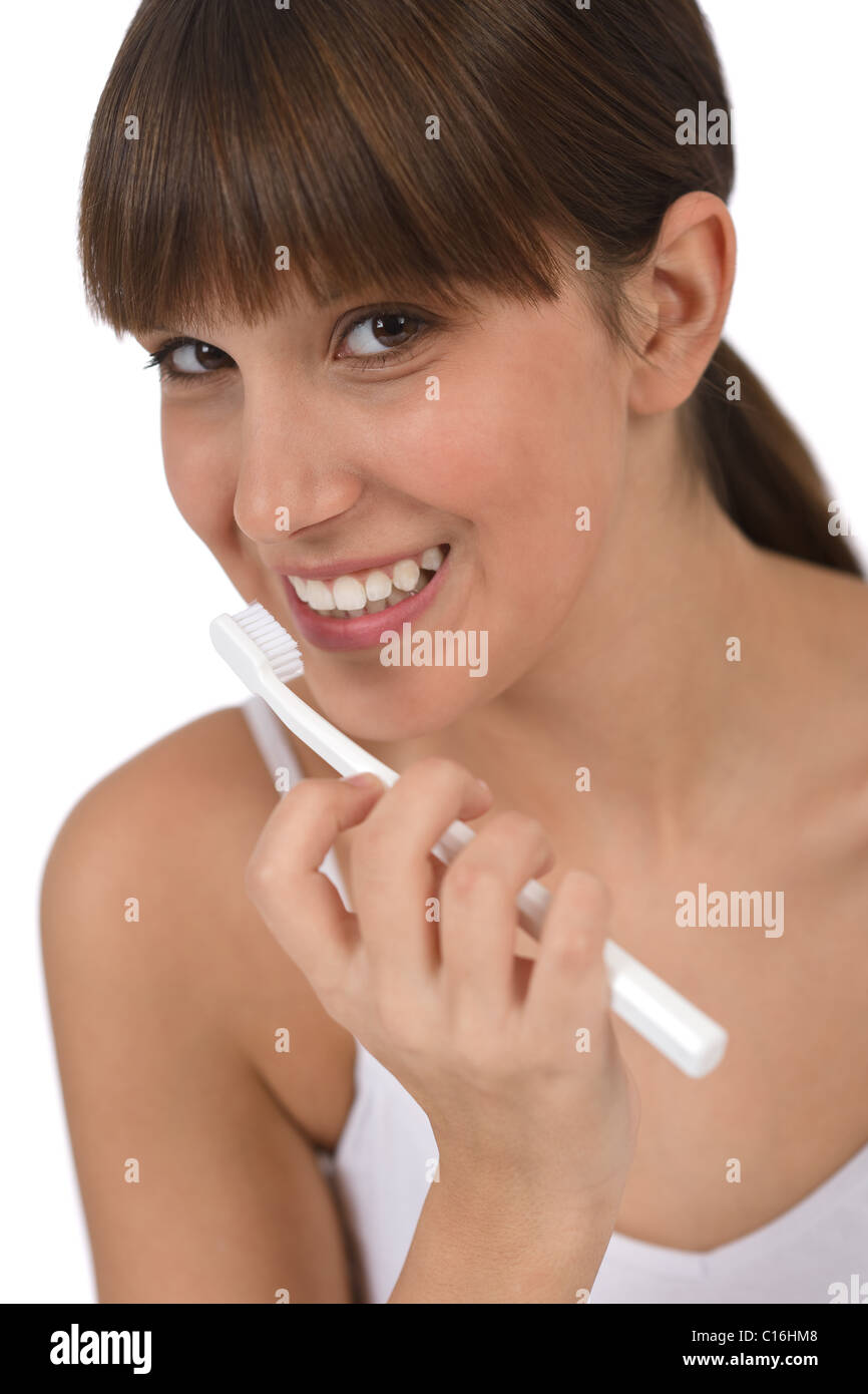 Body care - Female teenager brushing teeth with white toothbrush Stock ...