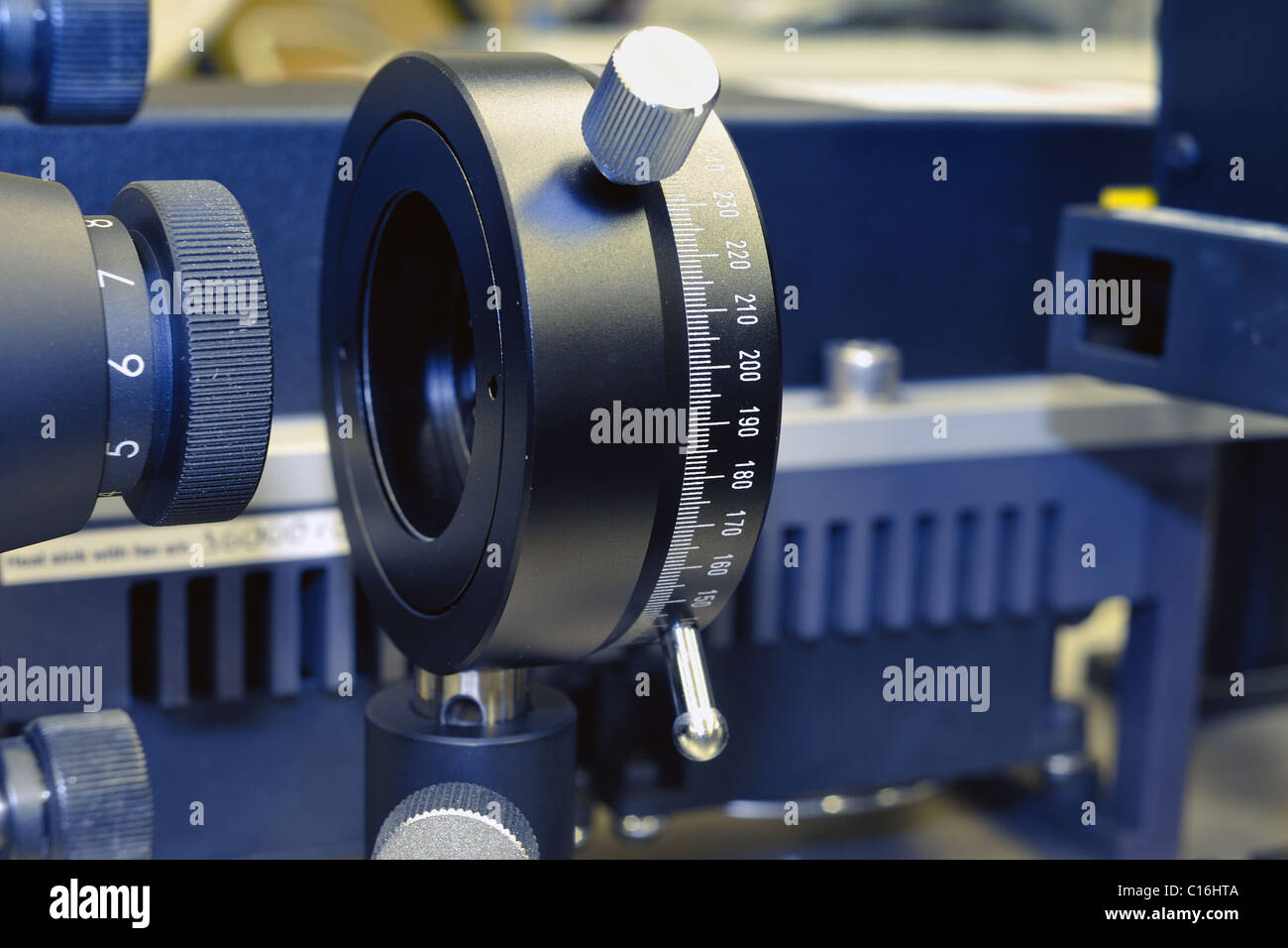abstract opto-mechanical fragment inside optical laboratory; selective ...