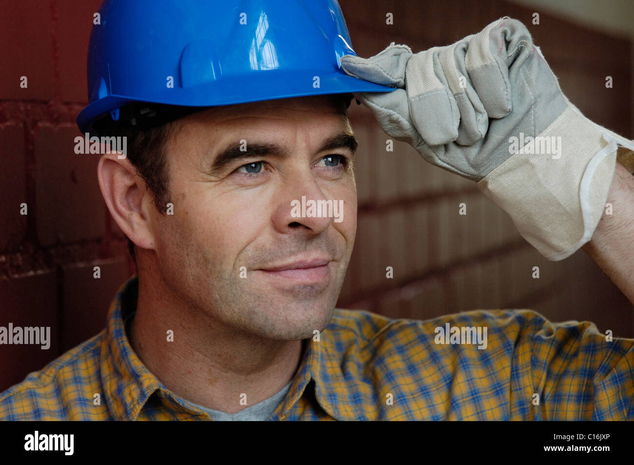 Portrait of a workman wearing a helmet Stock Photo - Alamy