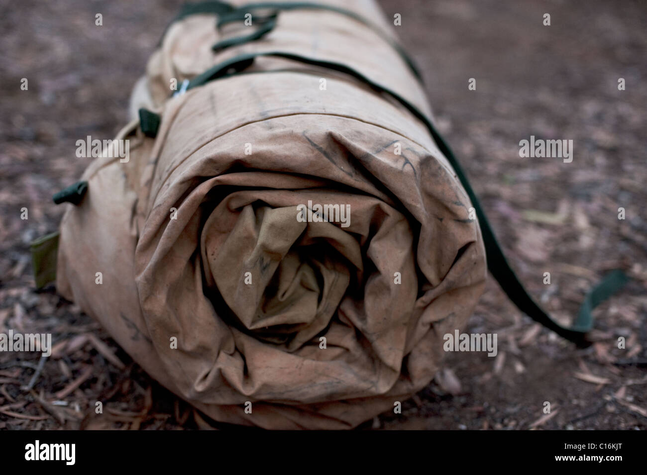 A traditional Australian canvass covered swag or sleeping bundle on the ... A traditional Australian canvass covered swag or sleeping bundle on the ...