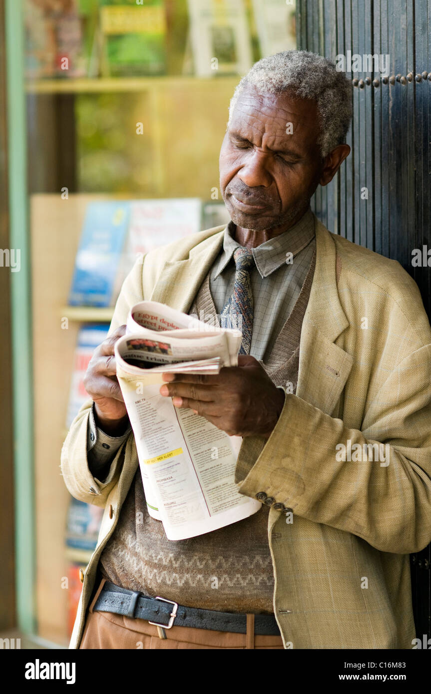 Man reading paper in City Centre Stock Photo - Alamy