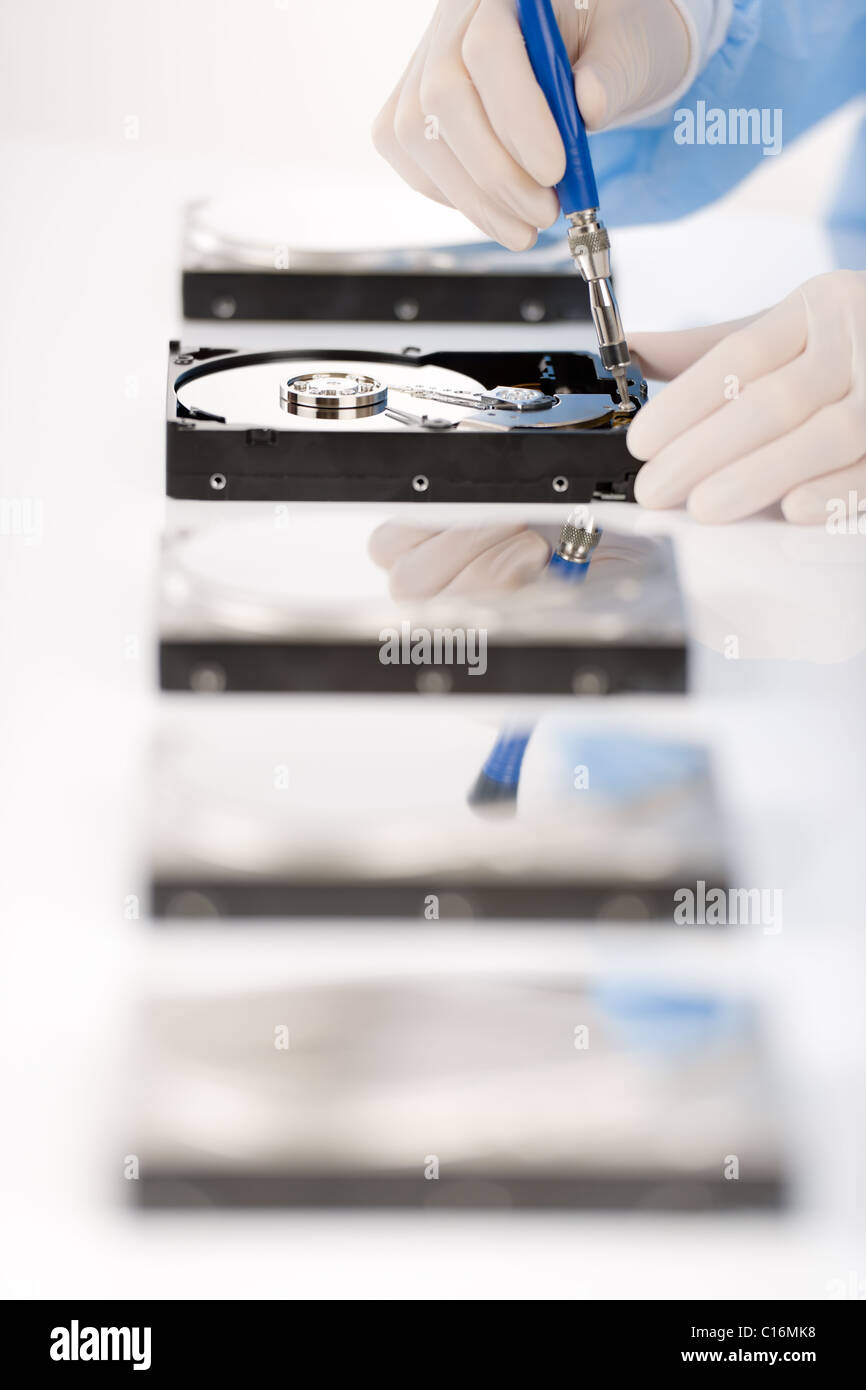 Computer engineer repair hard disc defect, experiment in sterile ...