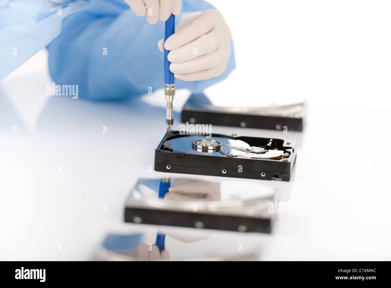 Computer engineer repair hard disc defect, experiment in sterile ...