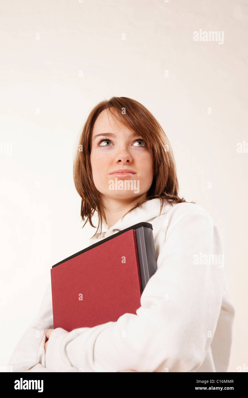 Girl holding documents, application documents, in her hand Stock Photo ...