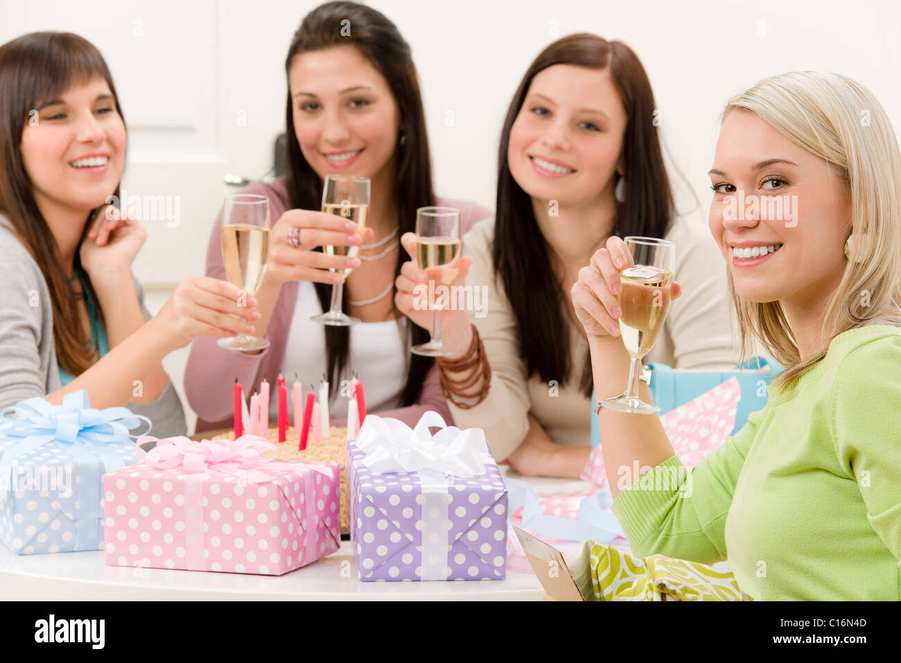 Birthday party - woman toasting with champagne, getting present Stock ...