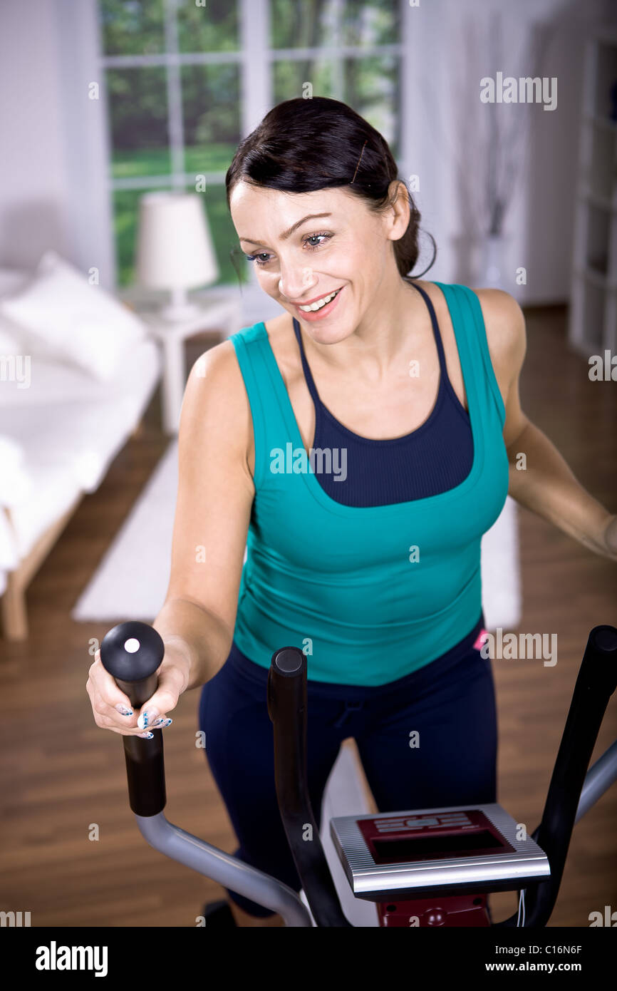 gym girl on cross-trainer Stock Photo - Alamy