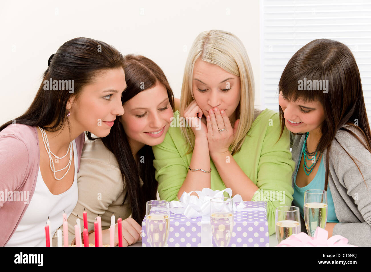 Birthday party - surprised woman getting present, champagne, cake Stock ...