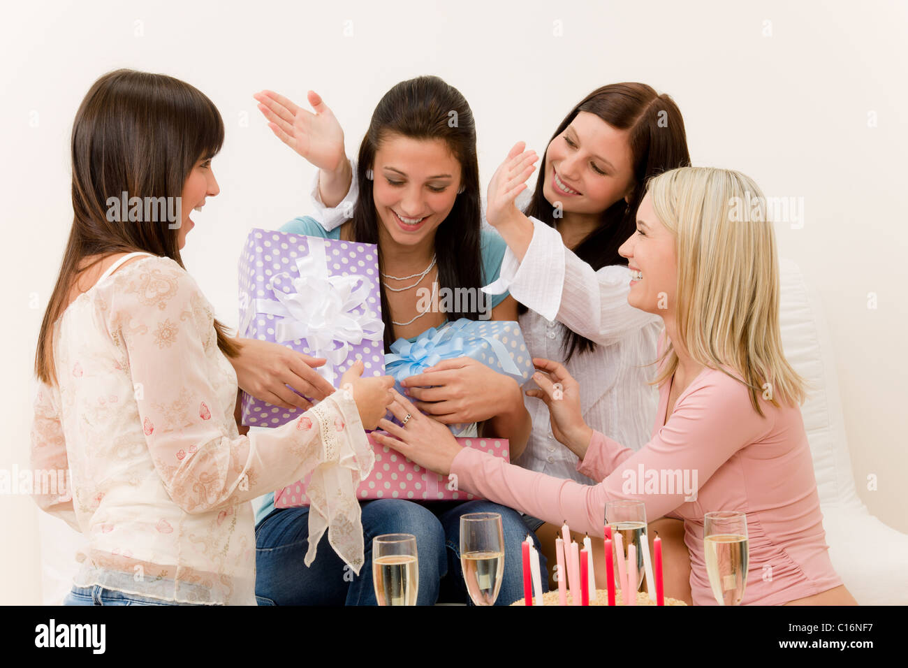 Birthday party - woman getting present, surprise, cake Stock Photo - Alamy