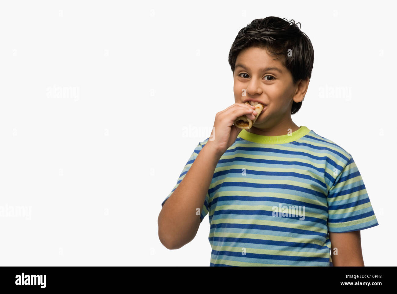 Portrait of a boy eating bread Stock Photo - Alamy
