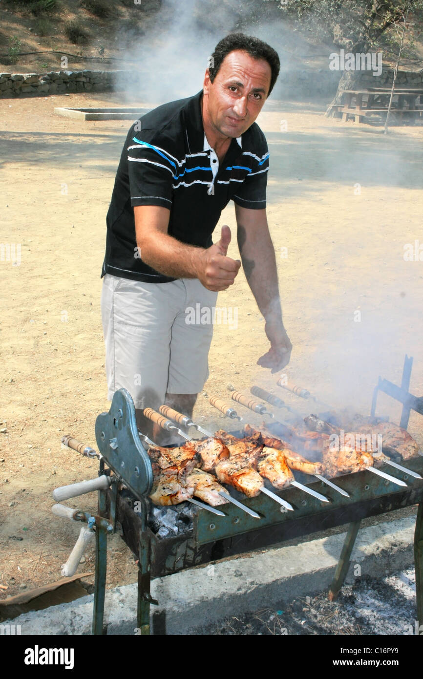 Man roasted barbecue at the charcoal Stock Photo - Alamy