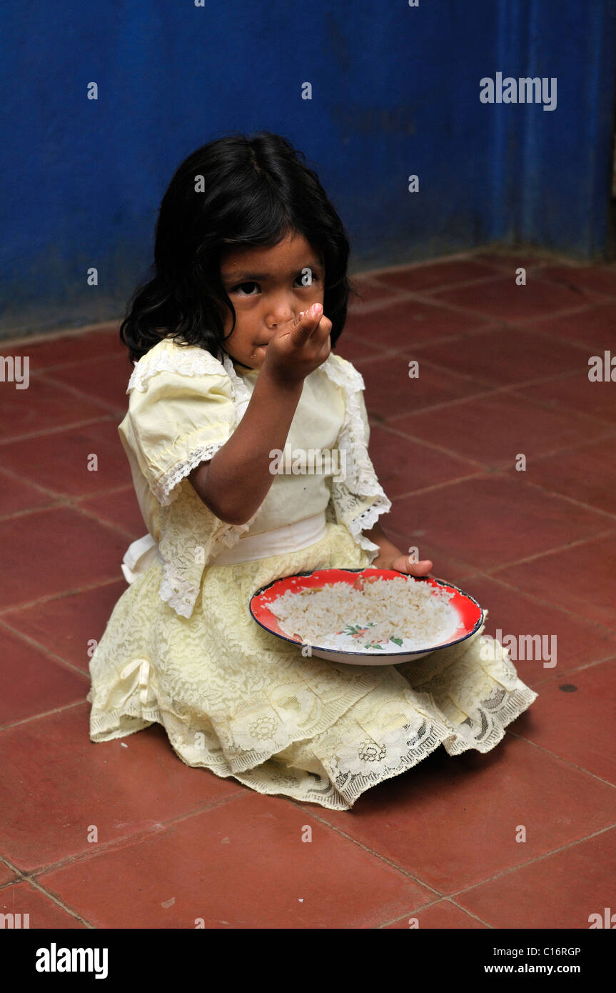 Child eating rice ground hi-res stock photography and images - Alamy