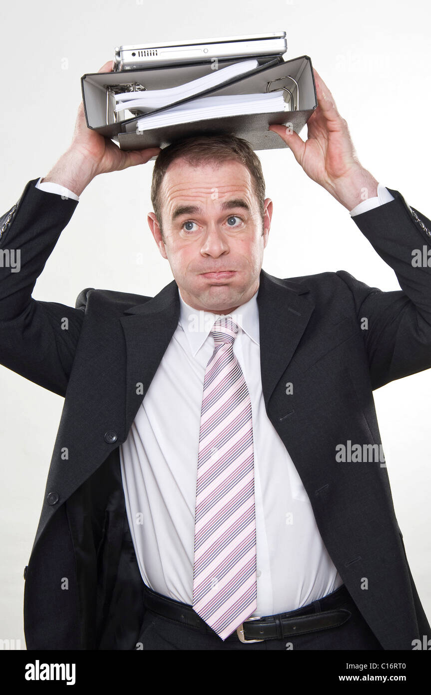 Businessman with document files piled on his head Stock Photo - Alamy