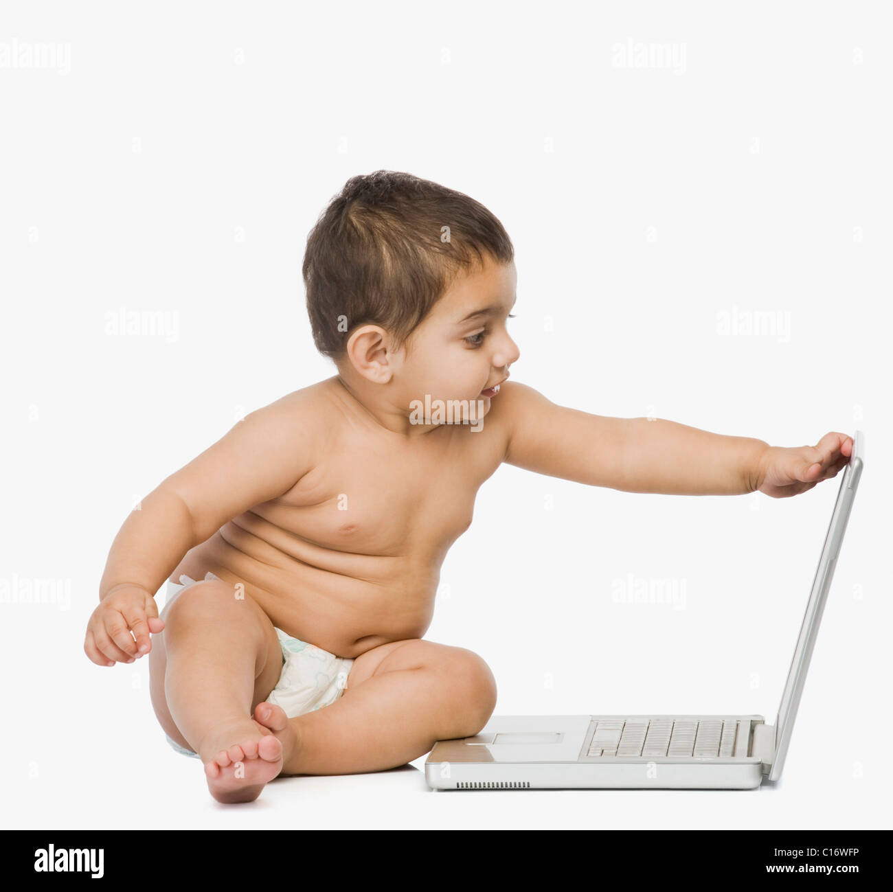 Baby boy playing with a laptop Stock Photo - Alamy