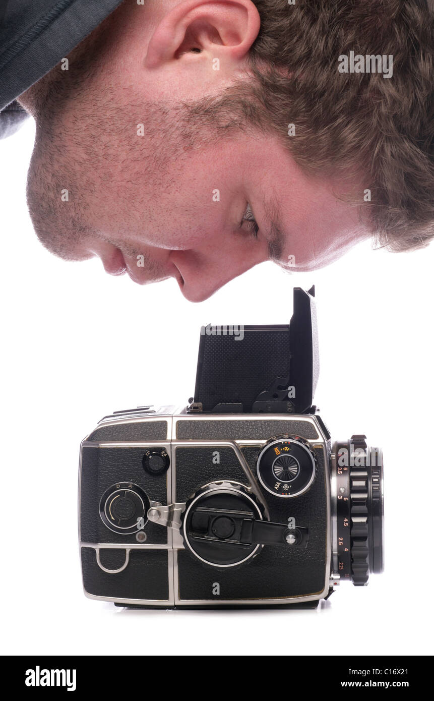 Man looking into medium format camera in studio Stock Photo - Alamy