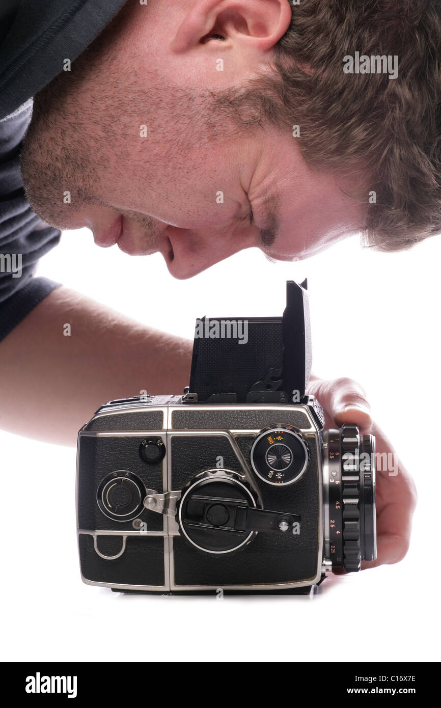 Man focusing medium format camera in studio Stock Photo - Alamy