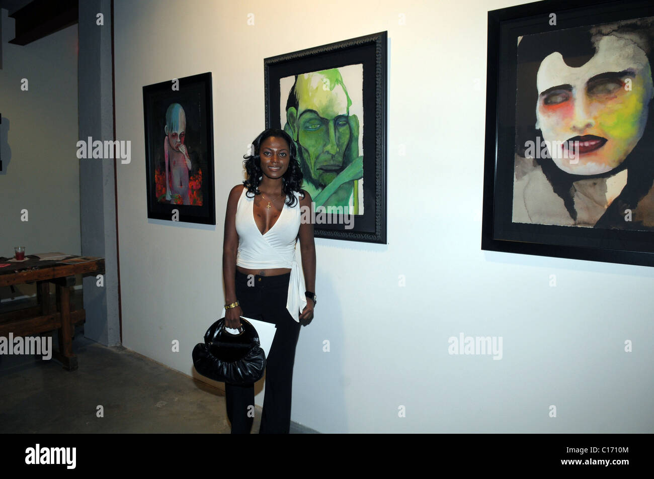 Fibi Love stands aside Marilyn Manson's art work inside the 101 Exhibit ...