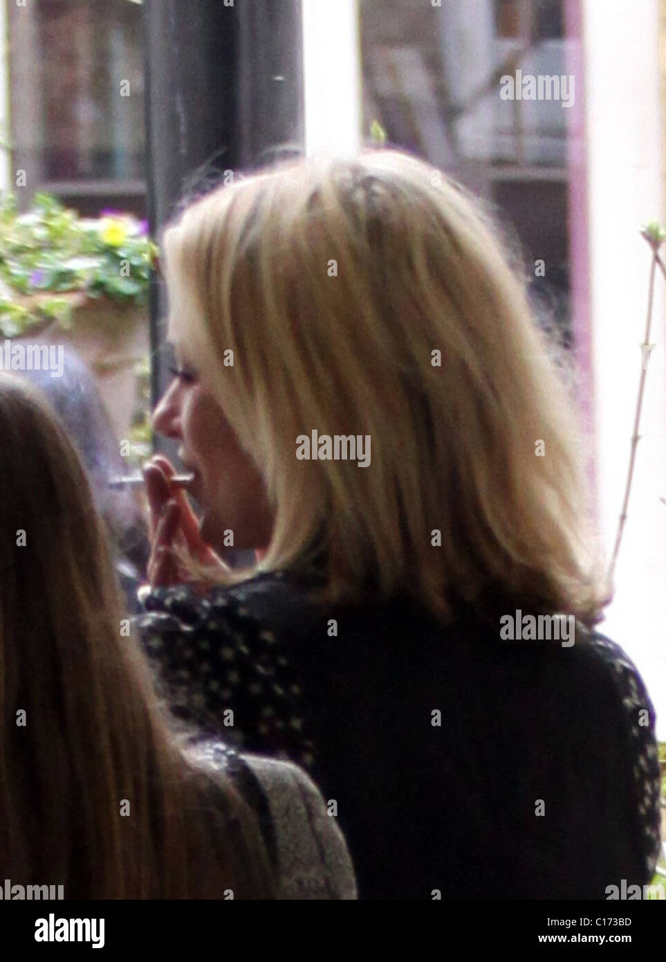 Kate Moss smokes a cigarette while filming for Comic Relief at an Art ...