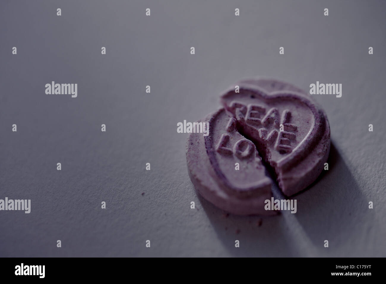 A broken love heart sweet with the message " Real Love Stock Photo - Alamy