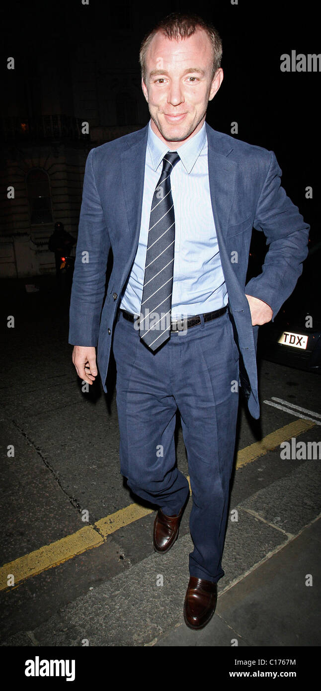 Guy Ritchie in a blue suit and brown shoes arrives at a restaurant in ...
