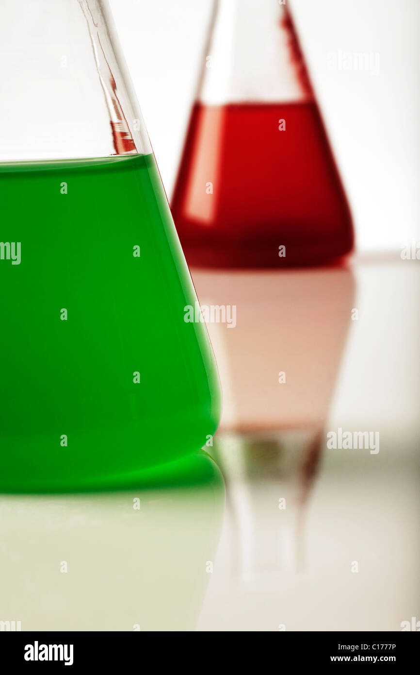 close up detail of laboratory beakers with different coloured liquid in ...