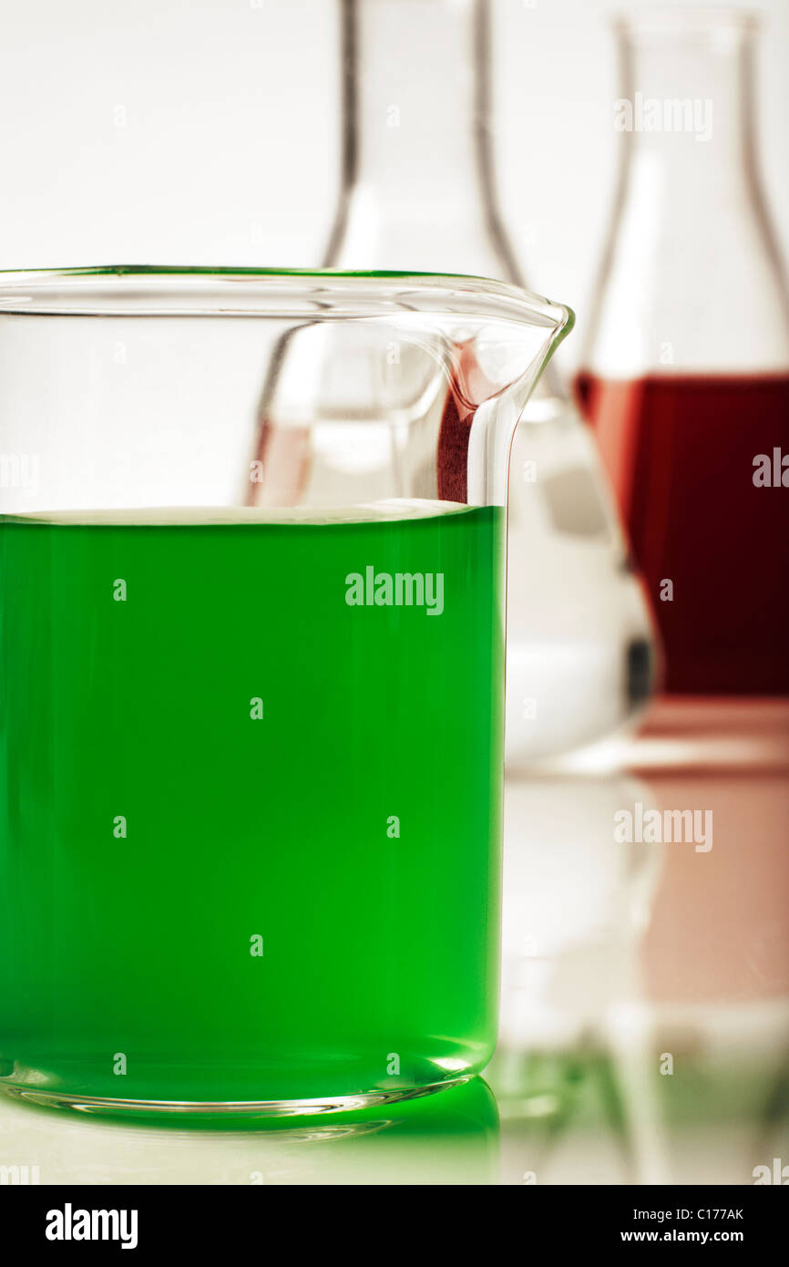 close up detail of laboratory beakers with different coloured liquid in ...