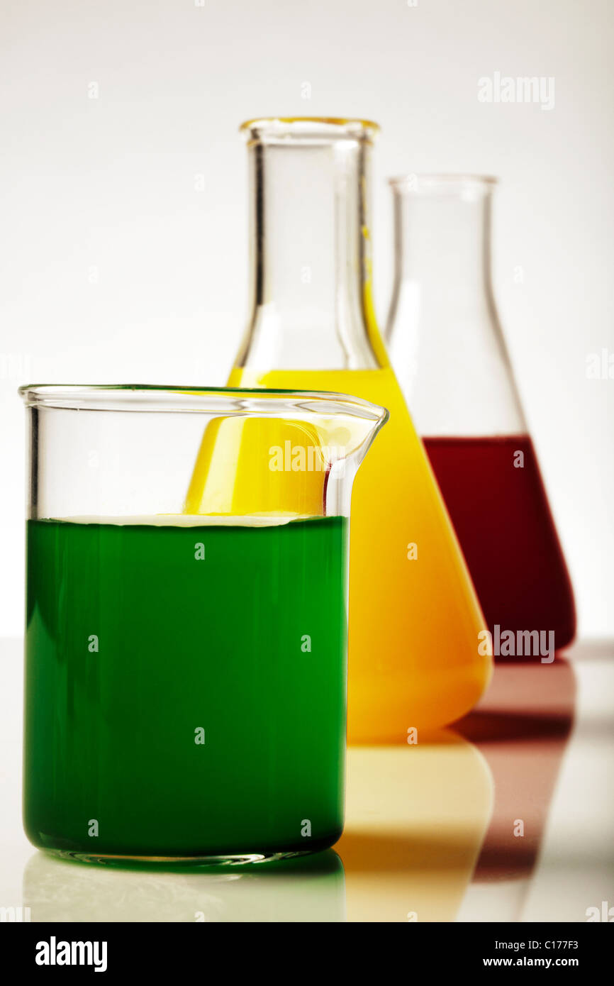 close up detail of laboratory beakers with different coloured liquid in ...