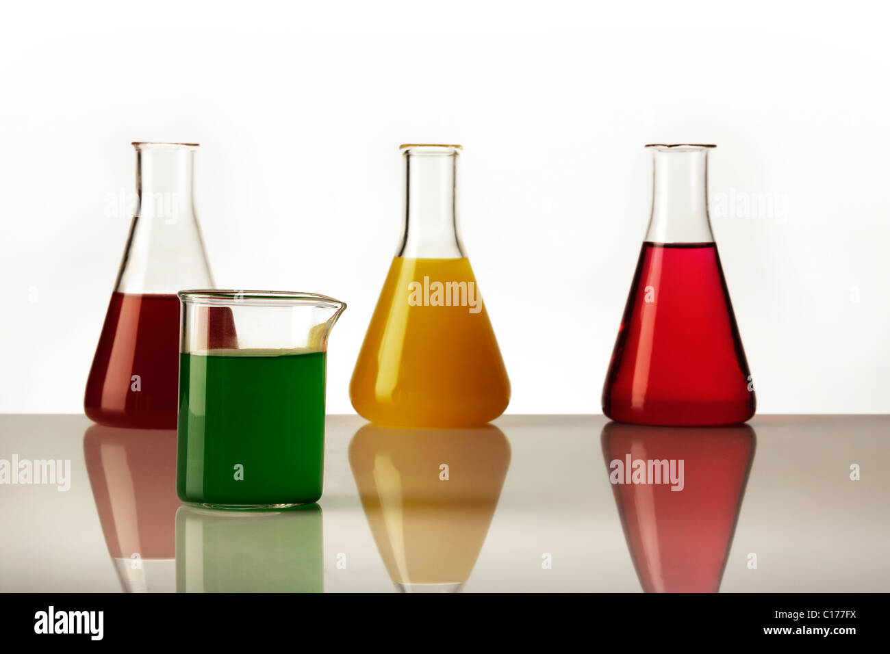 close up detail of laboratory beakers with different coloured liquid in ...