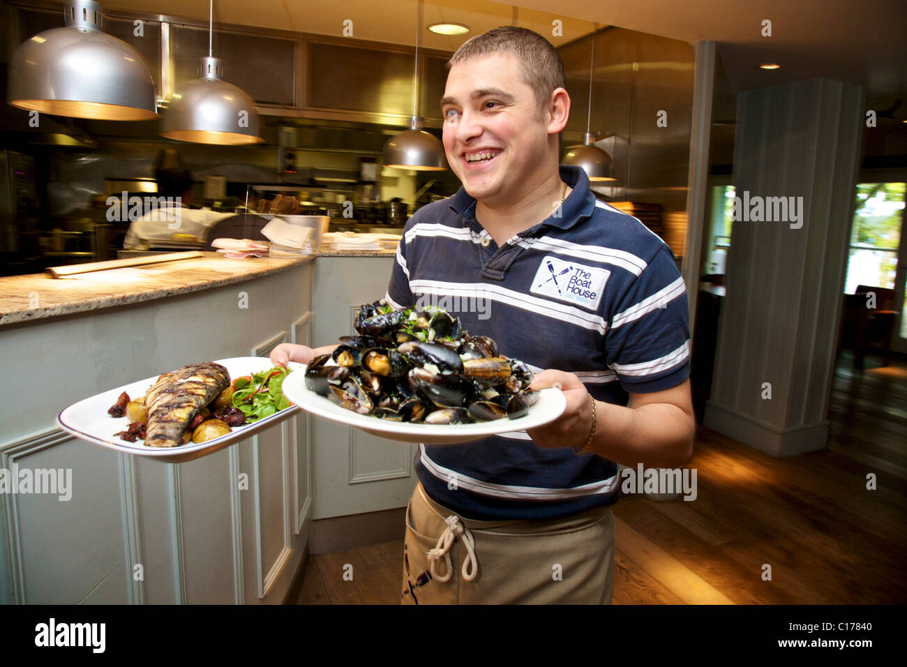 A waiter serves food in a restaurant Stock Photo - Alamy