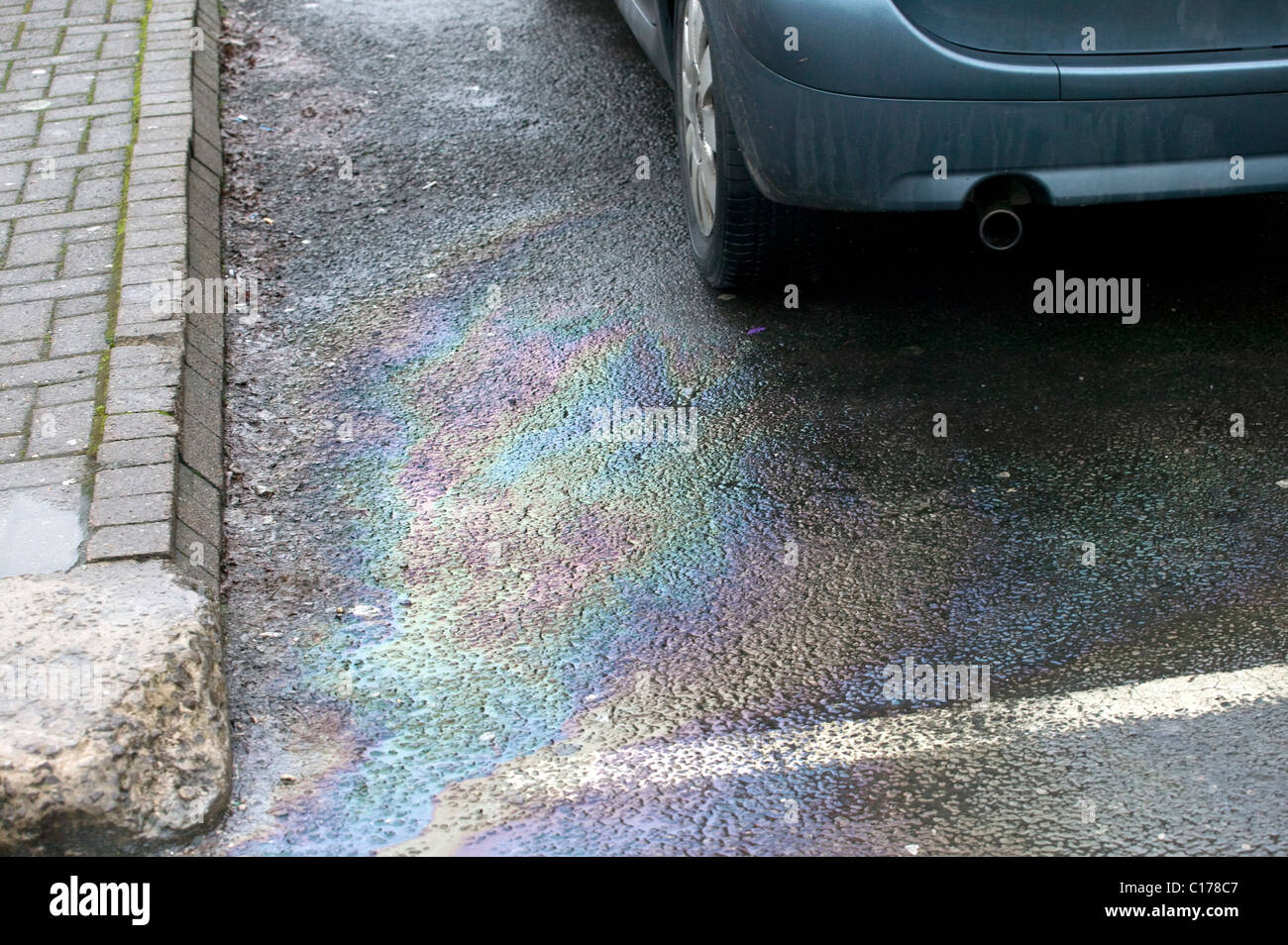 Petrol spilt from car in supermarket carpark causing pollution Stock ...