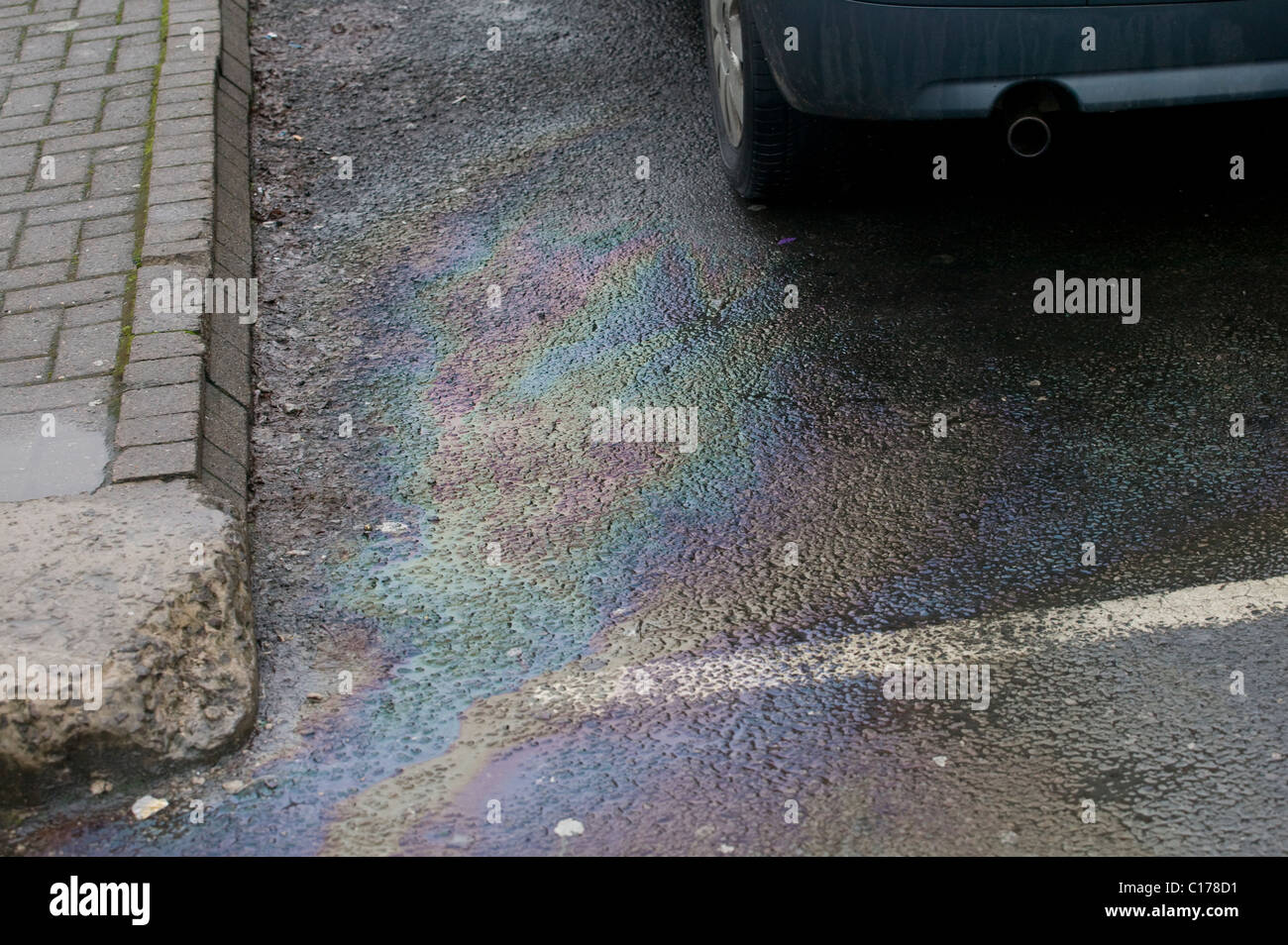 Petrol spilt from car in supermarket carpark causing pollution Stock ...