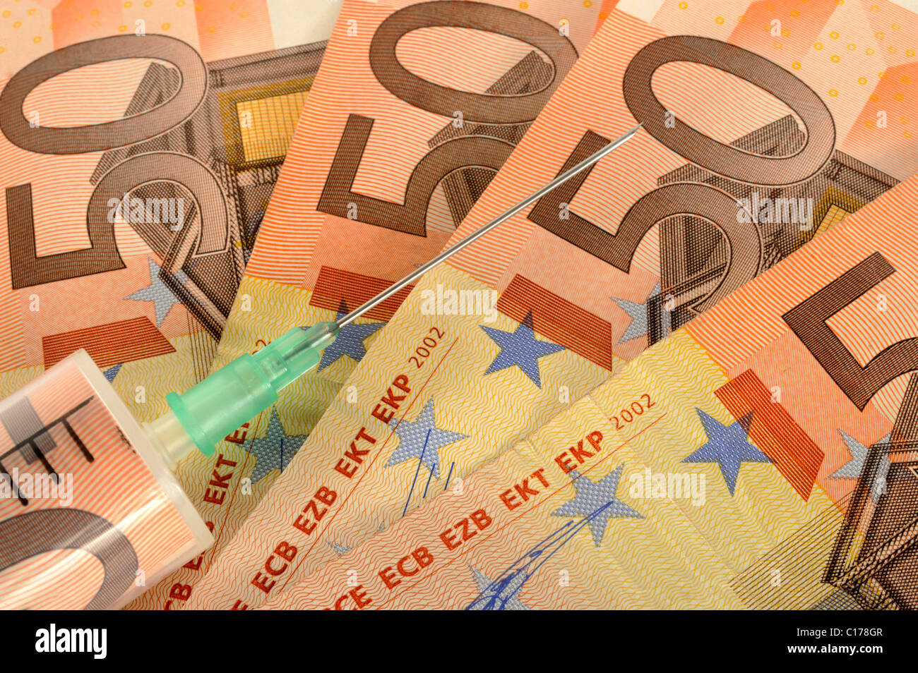 Euro bills and an injection needle, symbolic picture for cash injection ...
