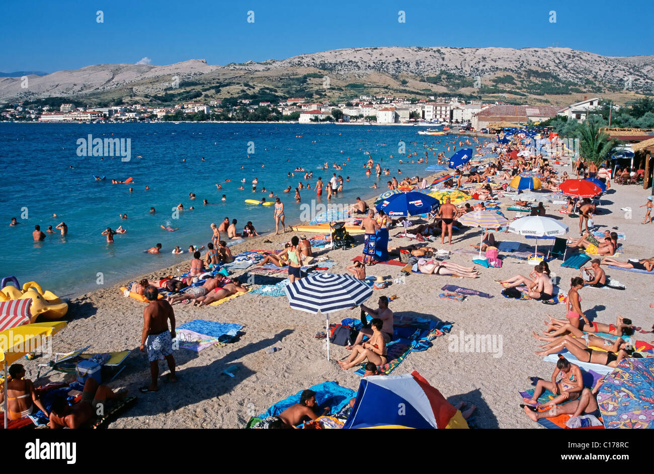 Pag beach. Crowded beach near old town Pag, Croatia Stock Photo - Alamy