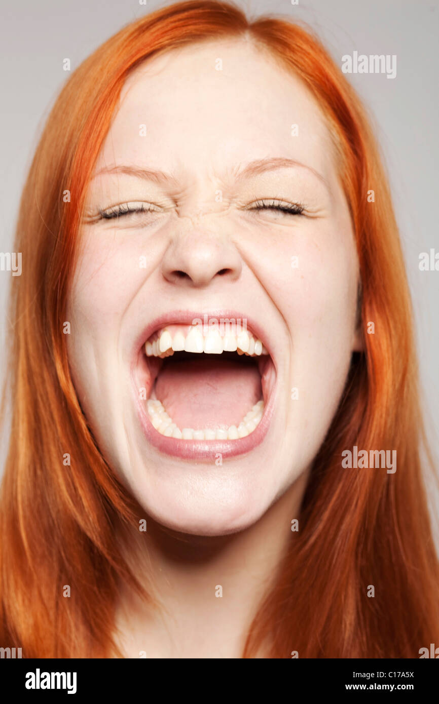 Portrait of a young, screaming red-haired woman Stock Photo - Alamy