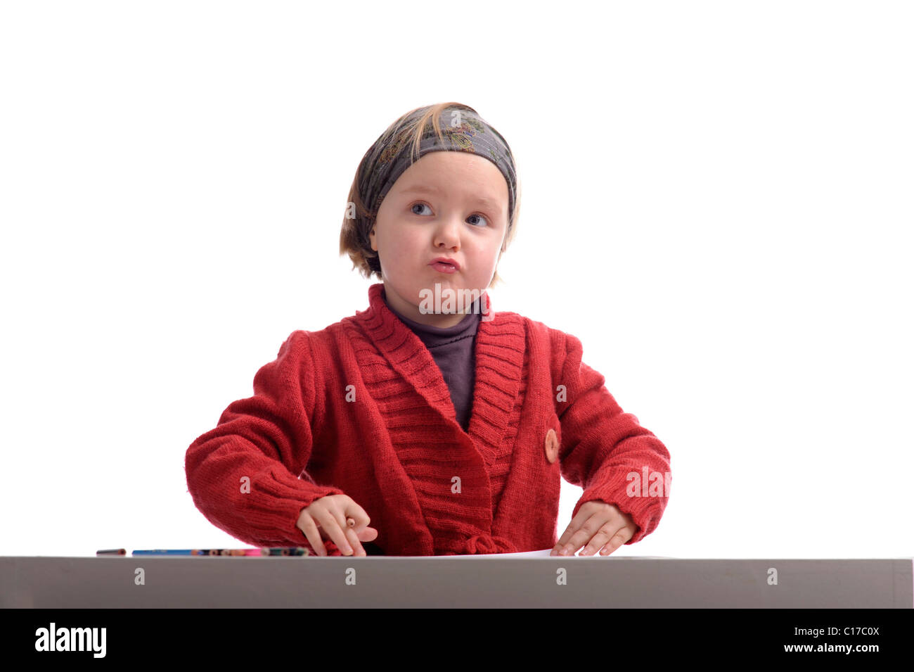Little girl in red drawing with pencils. Isolated on white background ...