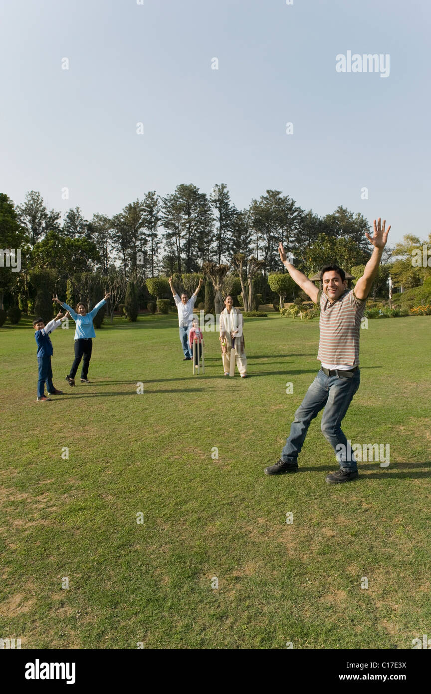 Family playing cricket in lawn Stock Photo - Alamy
