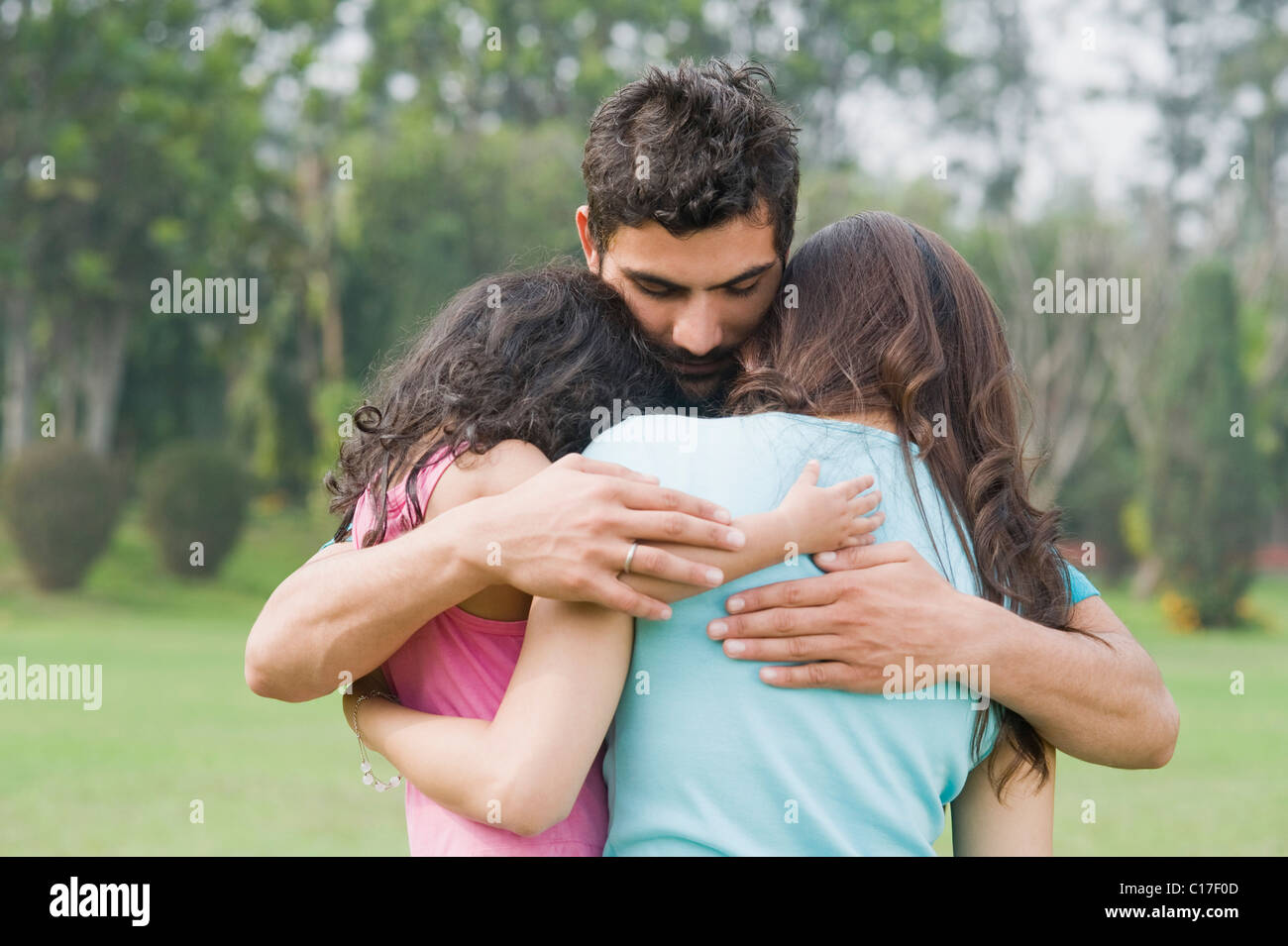 Rear view of parents hugging child hi-res stock photography and images ...
