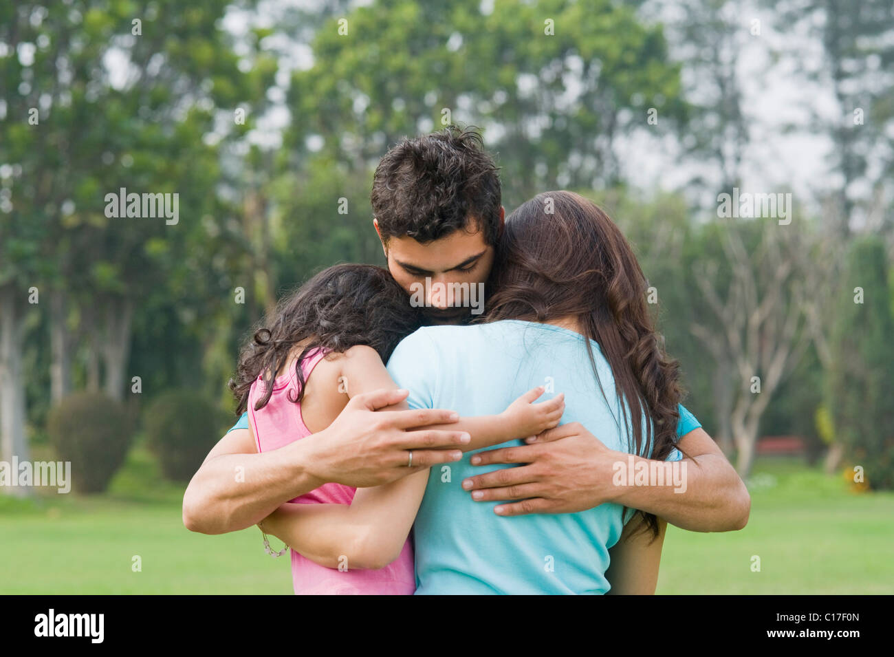 Rear view of parents hugging child hi-res stock photography and images ...