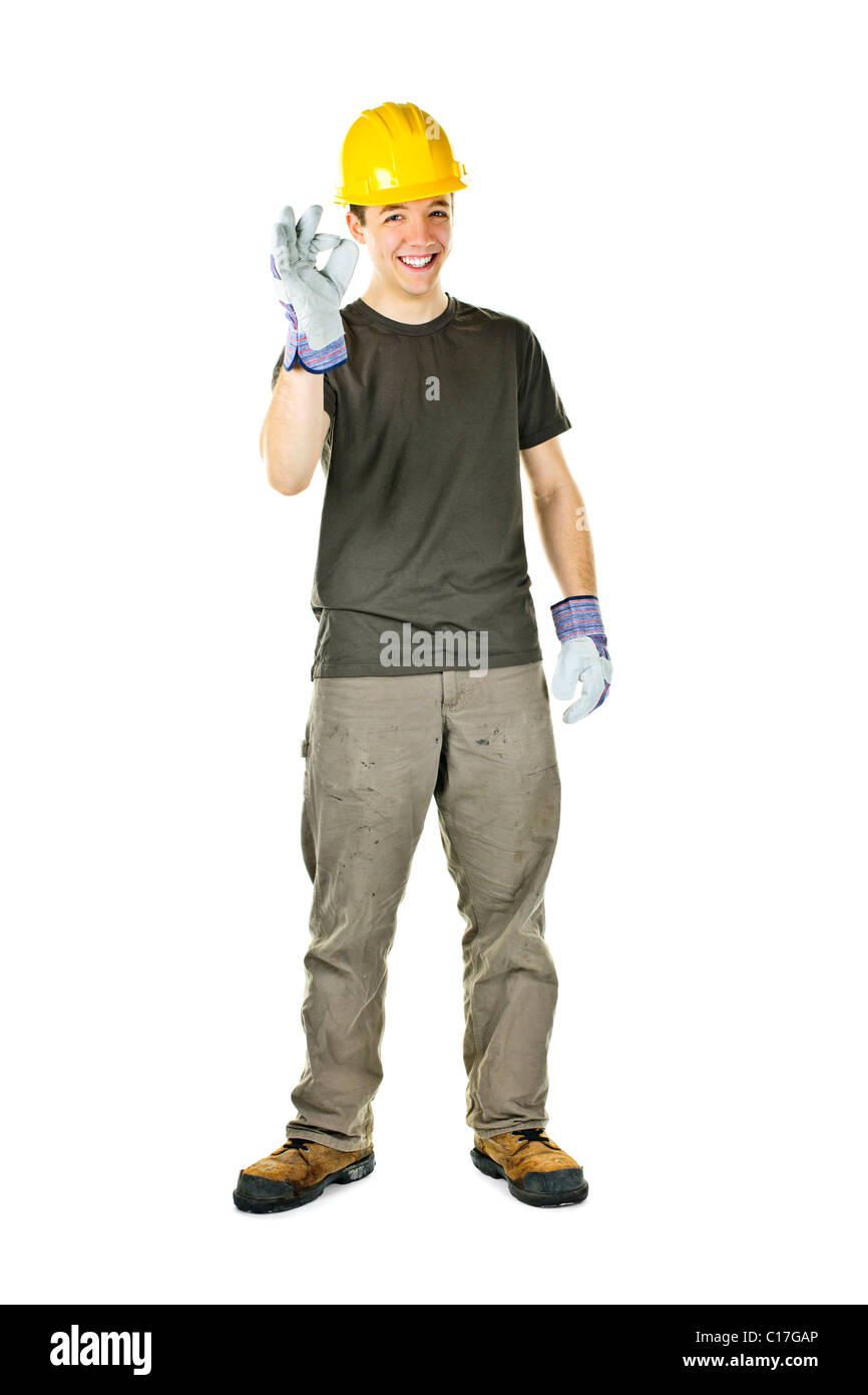Smiling construction worker showing okay sign standing isolated on ...