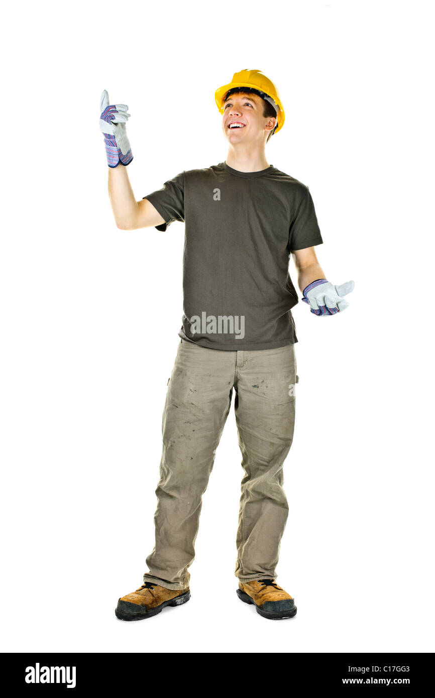 Smiling construction worker pointing up standing isolated on white ...